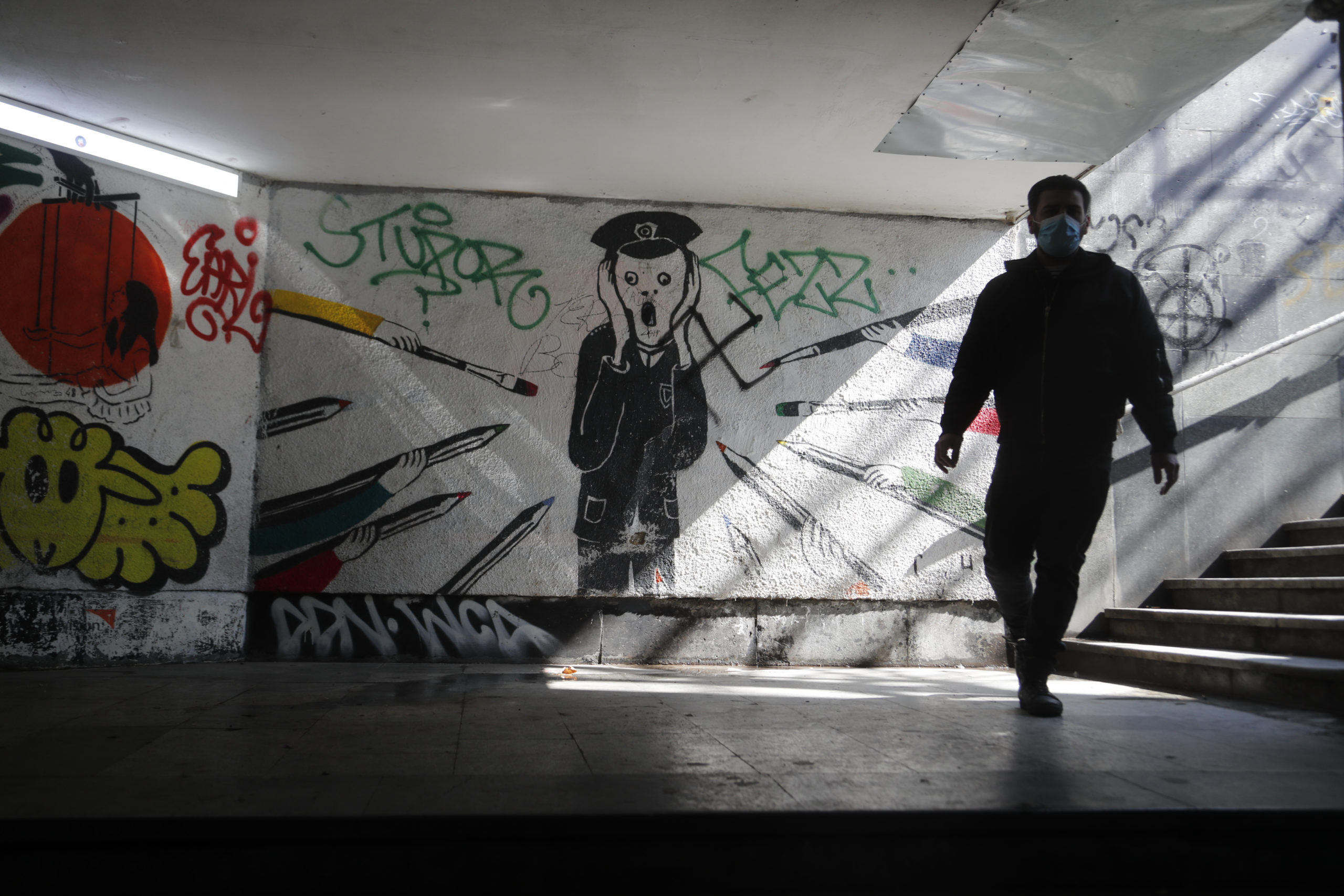 A man passes graffiti painted in an underpass in Tbilisi. – The Tribune