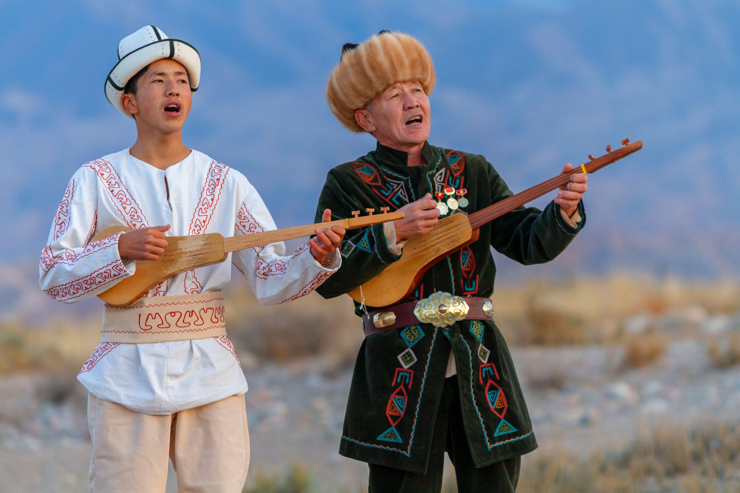 Kyrgyz musicians playing the Komuz, a traditional musical instrument in ...